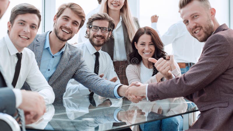 Happy Business People Confirming the Transaction with a Handshake Stock ...