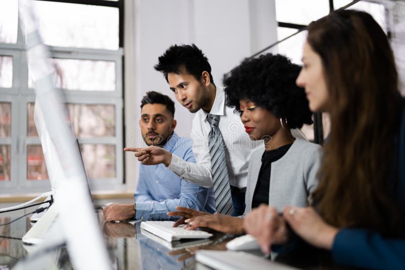 Happy Business People Using Laptop Discussing at Workplace Stock Image ...