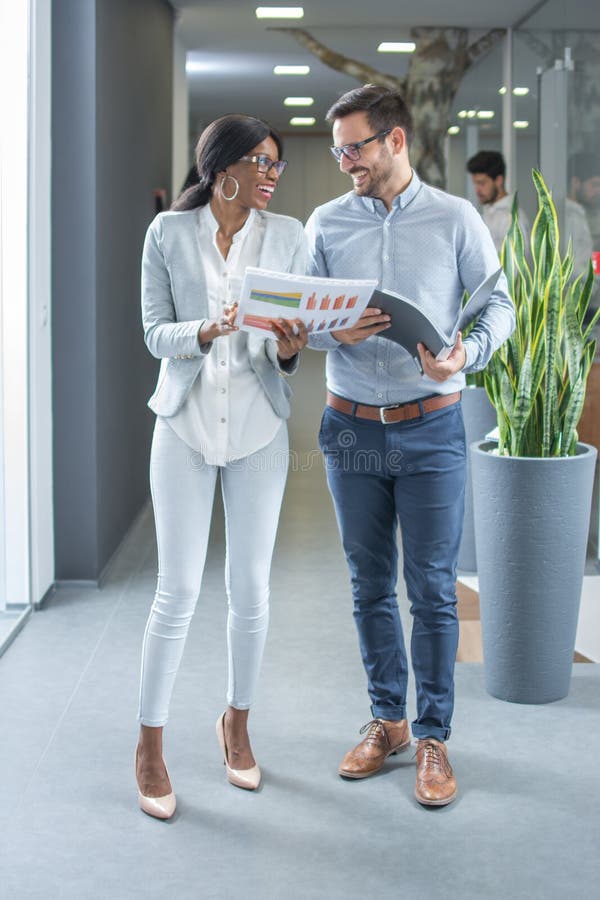 Happy Business People Working Together with Document while Walking ...