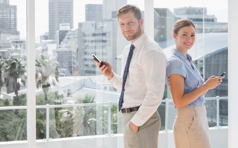 Happy Business Team Standing Back To Back and Texting Stock Photo ...