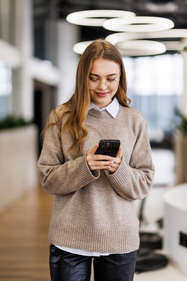 Happy Business Woman Text Messaging through Mobile Phone at Office ...
