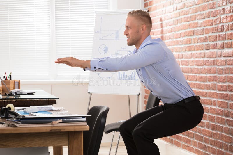 Businessman Doing Exercise in Office Stock Photo - Image of business ...