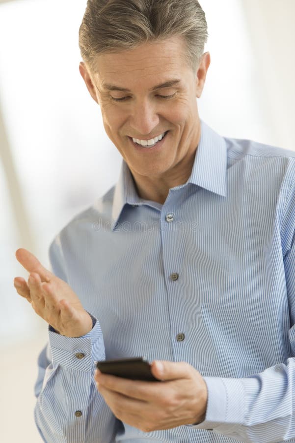 Happy Businessman Gesturing while Reading Text Message Stock Photo ...