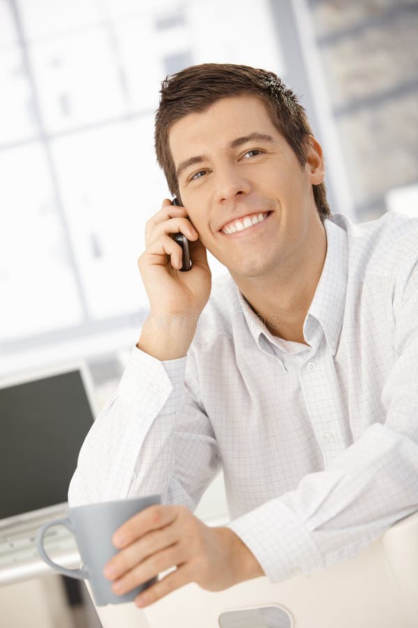 Businessman on Phone Looking at Photo Frame Stock Photo - Image of ...