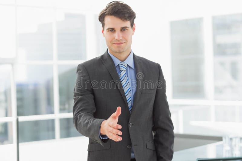 Man Extending Hand for Handshake while Standing in Modern Office with ...