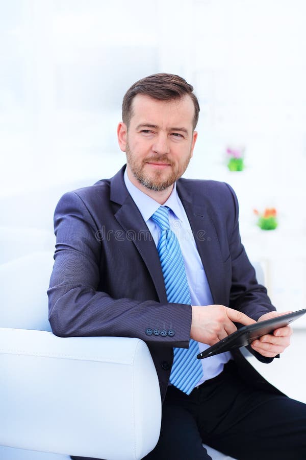 Happy Businessman Sitting on the Sofa Looking at Camera in the Office ...
