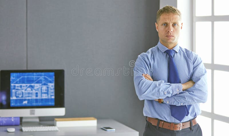 Happy Businessman Standing Behind Office Desk, Smiling Stock Photo ...