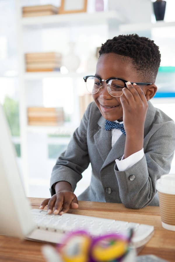 Happy Businessman Wearing Eyeglasses while Using Computer Stock Photo ...