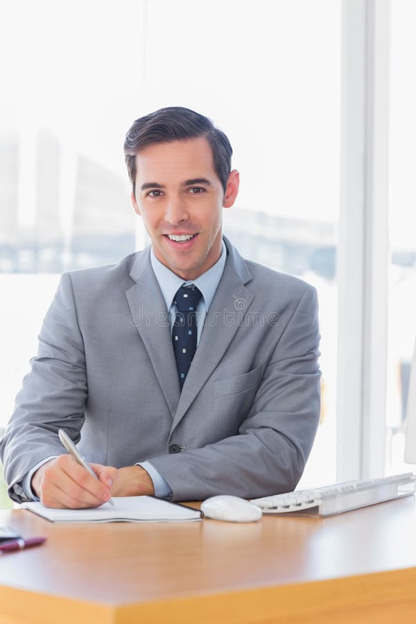 Happy Businessman Writing at His Desk Stock Image - Image of jacket ...