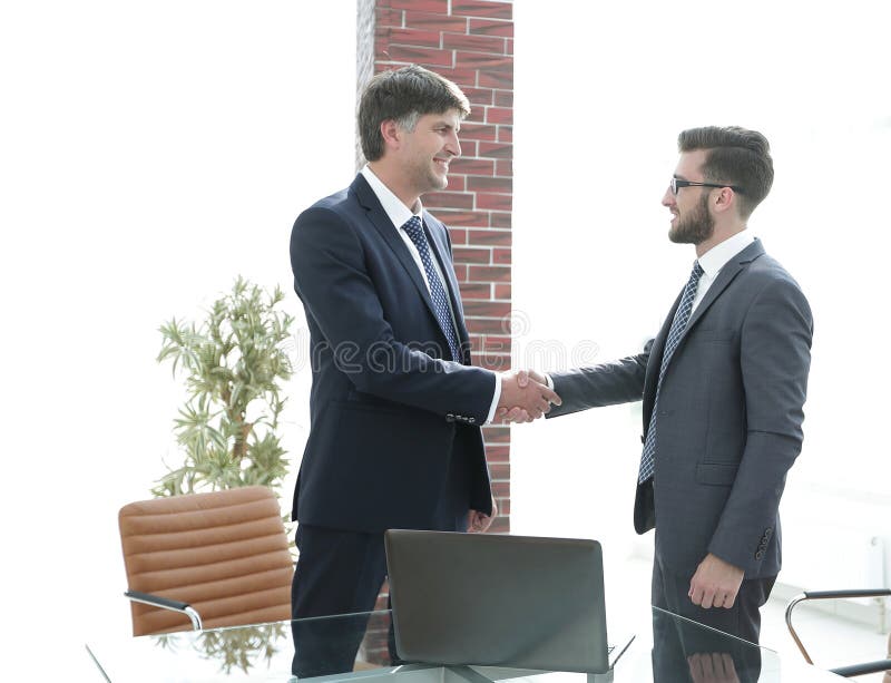 Businessmen Shaking Hands while Standing in Office Corridor Stock Image ...