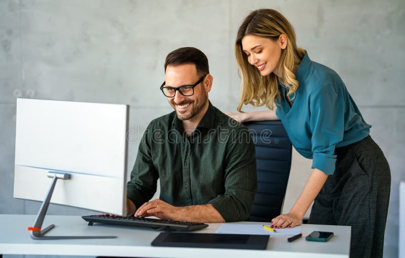 Happy Businesspeople Laughing while Collaborating on a New Project in ...