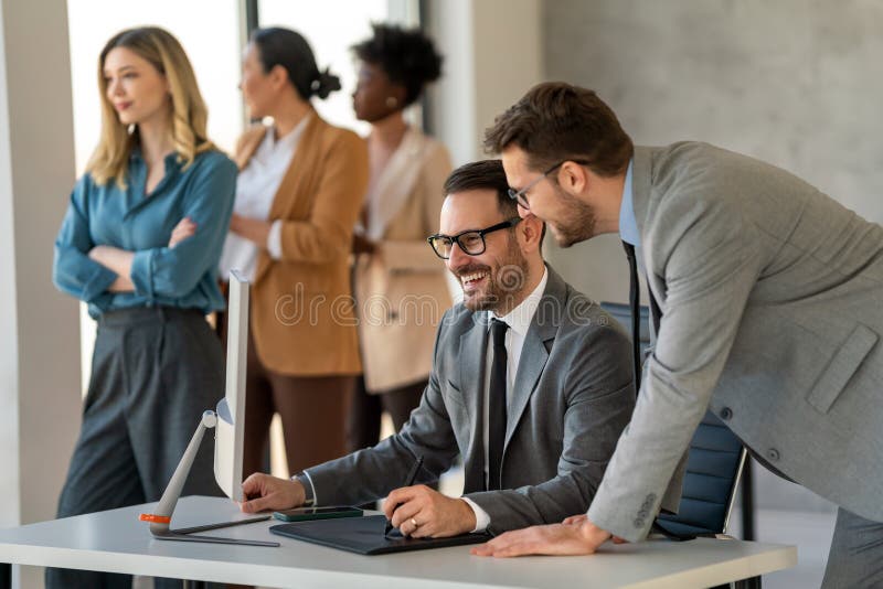 Happy Businesspeople Laughing while Collaborating on a New Project in ...