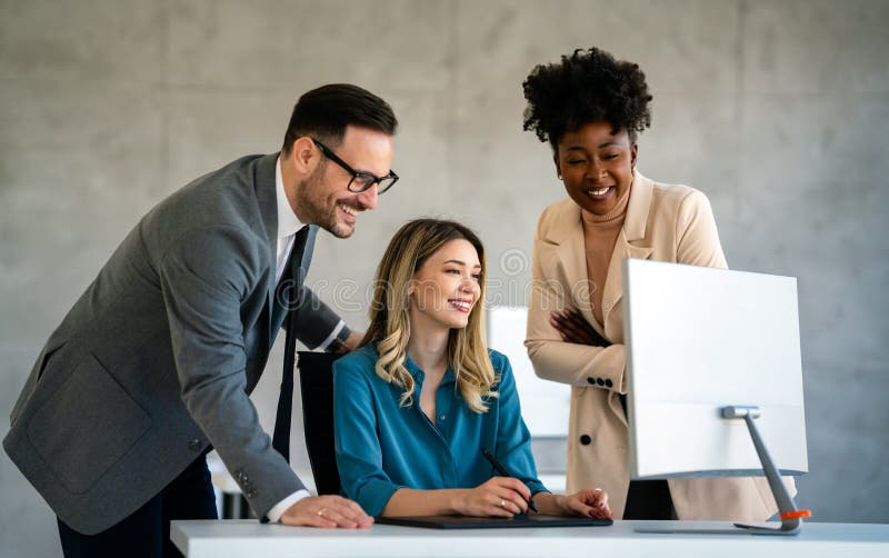 Happy Businesspeople Laughing while Collaborating on a New Project in ...