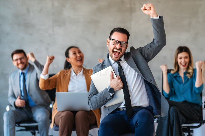 Happy Businesspeople Laughing while Collaborating on a New Project in ...