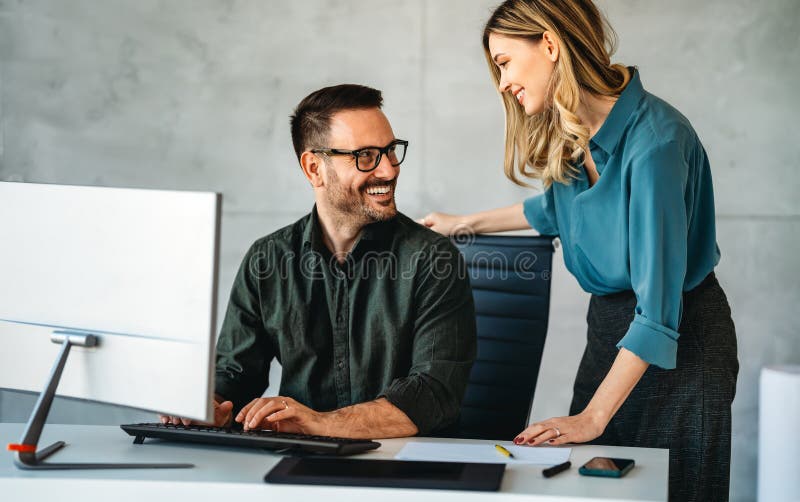 Happy Businesspeople Laughing while Collaborating on a New Project in ...