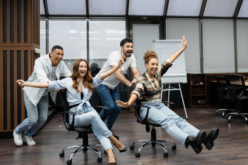 Happy Businesspeople Laughing while Collaborating on a New Project in ...
