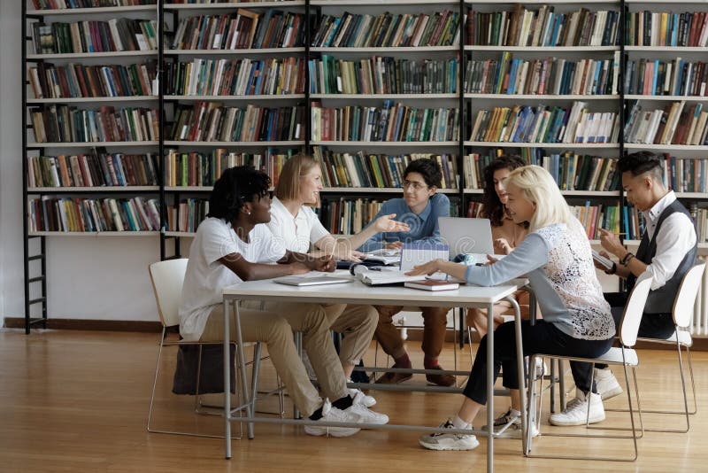 Happy Busy Multiethnic Group of Students Discussing Study Project Stock ...