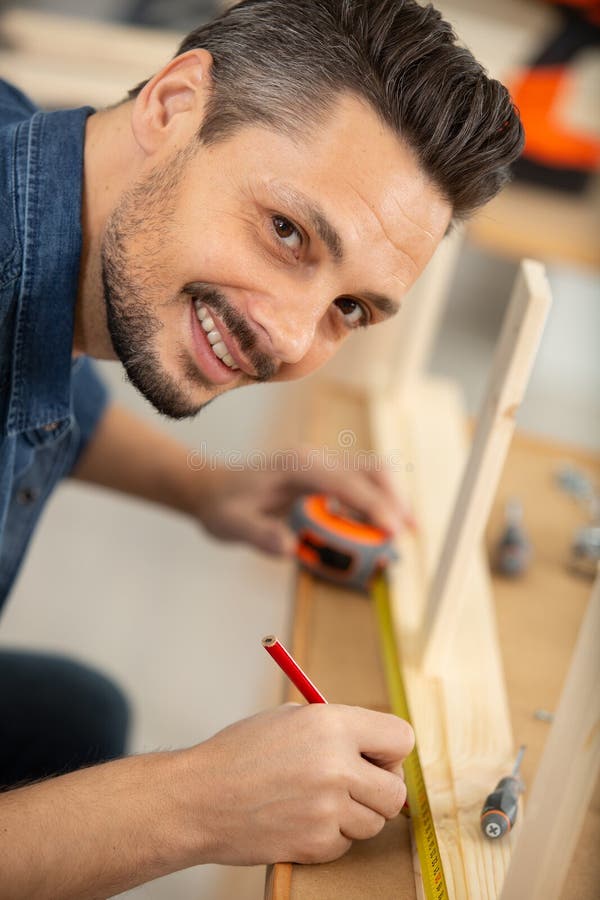 Happy Carpenter Using Measuring Tape Stock Image - Image of ...