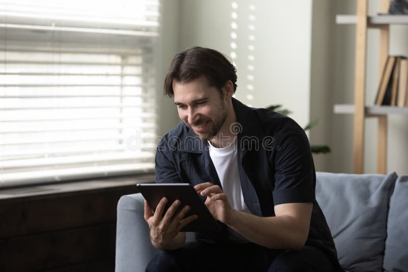 Happy Cheerful Gadget User Browsing Internet on Tablet at Home Stock ...