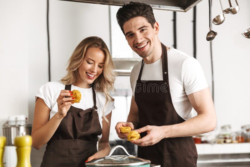 Happy Chef Couple Dressed in Aprons Cooking Stock Image - Image of ...