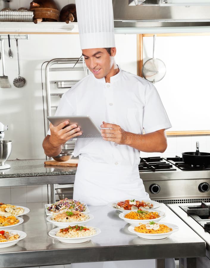 Chef Using Digital Computer in Kitchen Stock Image - Image of digital ...