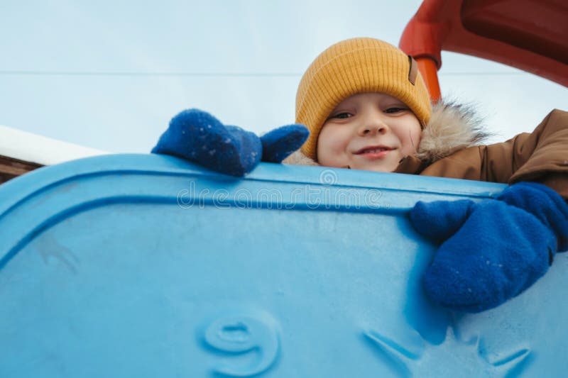 Happy Child Boy is Playing on Playground on a Slide Outside in Winter ...