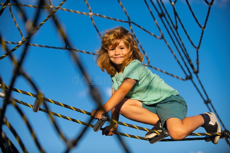 Happy Child Boy Playing on the Rope Outdoor Playground. Stock Image ...