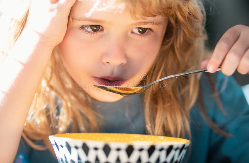 Happy Child Boy with Spoon Eats Itself Soup. Kid Eating Food on Kitchen ...