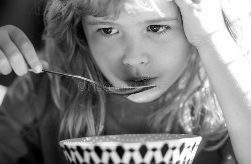 Happy Child Boy with Spoon Eats Itself Soup. Kid Eating Food on Kitchen ...