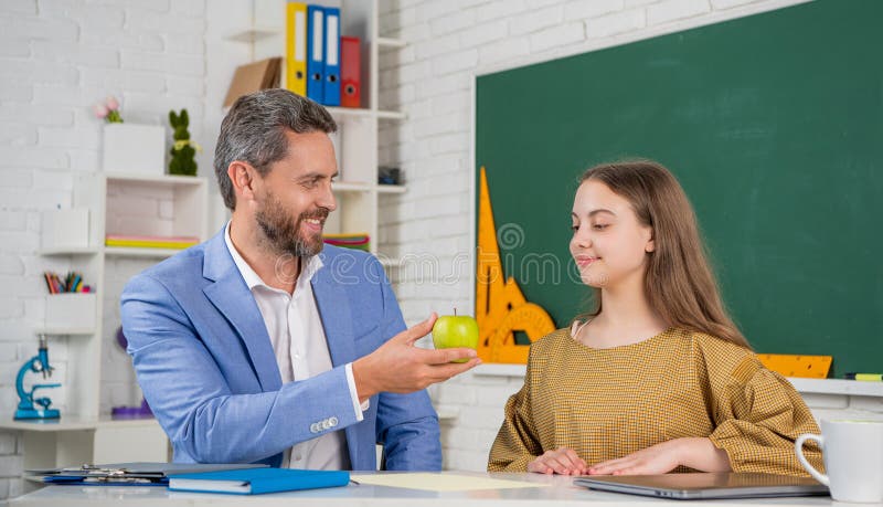 Happy Child in Classroom with Tutor Sharing Apple Stock Photo - Image ...