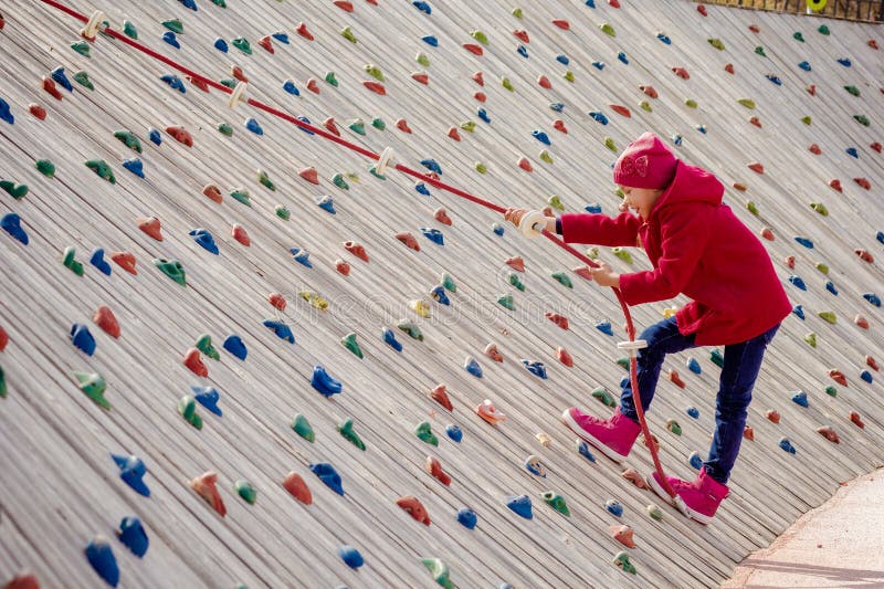 Happy Child Climbing on Artificial Rock Wall on Playground Stock Photo ...