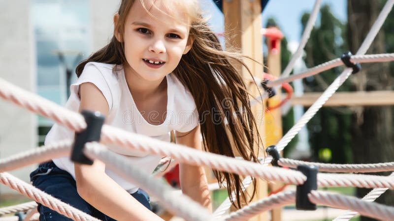 Happy Child Climbing the Net in the Playground Stock Photo - Image of ...