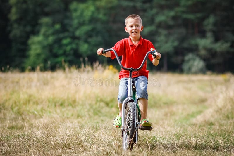A Happy Child Cycling in the Park Concept in Nature Stock Photo - Image ...
