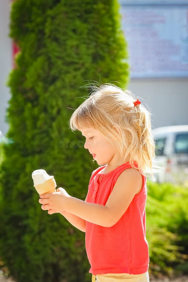 Happy Child Eating Ice Cream on the Nature of the Park Stock Image ...