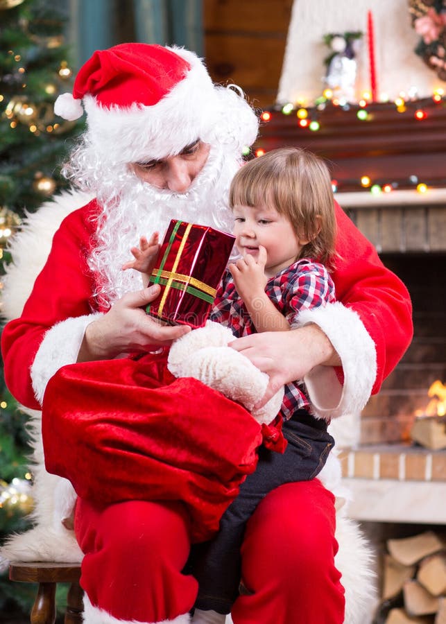 Happy Child with Gift Sitting on Santa Claus Lap Stock Photo - Image of ...