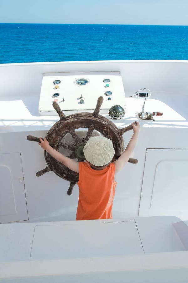 Happy Child at the Helm of the Ship in the Sea Background Stock Image ...