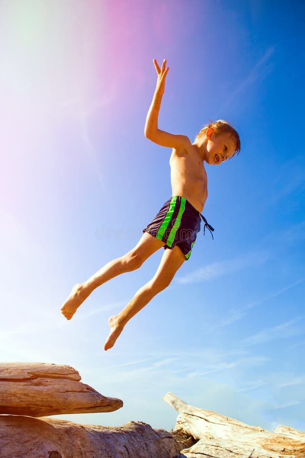 Happy Child jumping stock image. Image of blond, playful - 139934507