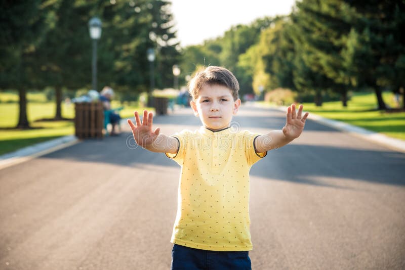 Happy Child Making a Stop Sign with His Hand while Standing at the Road ...