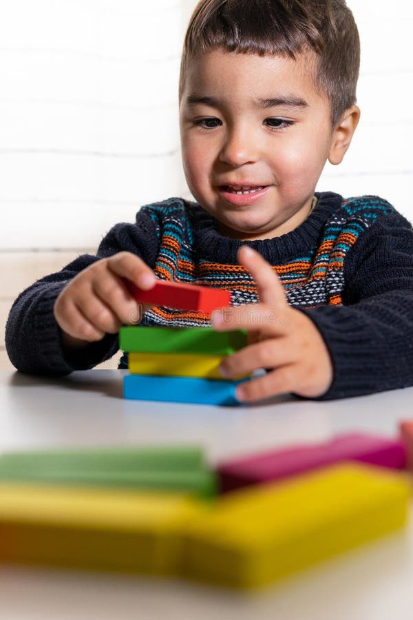 Happy Child Playing Building Blocks. Playing and Learning at Home ...