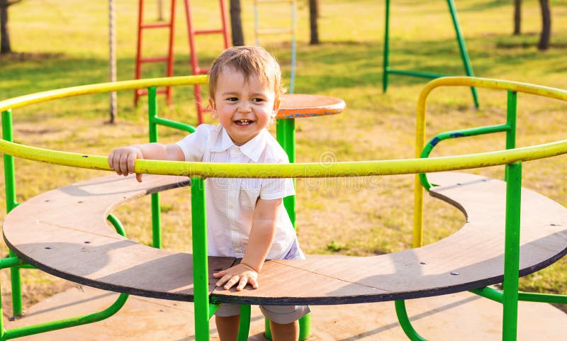 Happy Child Playing at a Playground. Stock Photo - Image of child ...