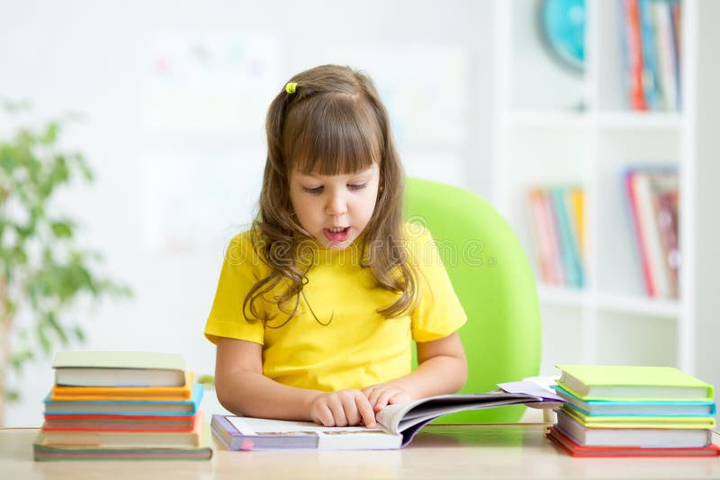 Happy Child Reading Book at Table in Nursery Stock Image - Image of ...