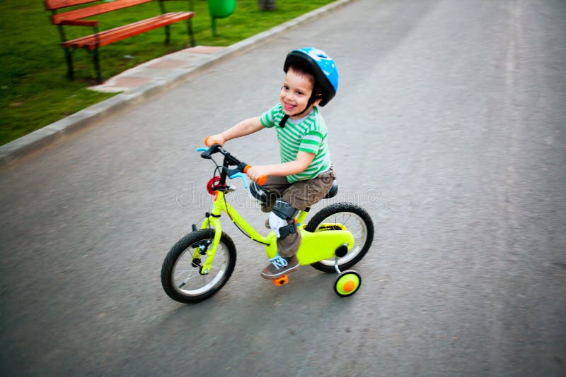 Happy child riding bike stock image. Image of protection - 23747651