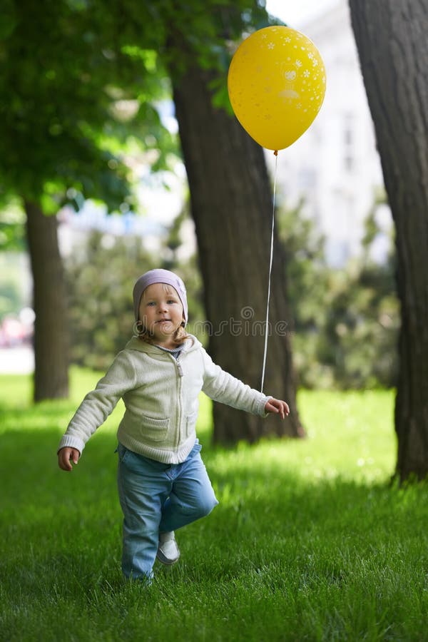 Happy Toddler Running with Balloons in Field Stock Photo - Image of ...