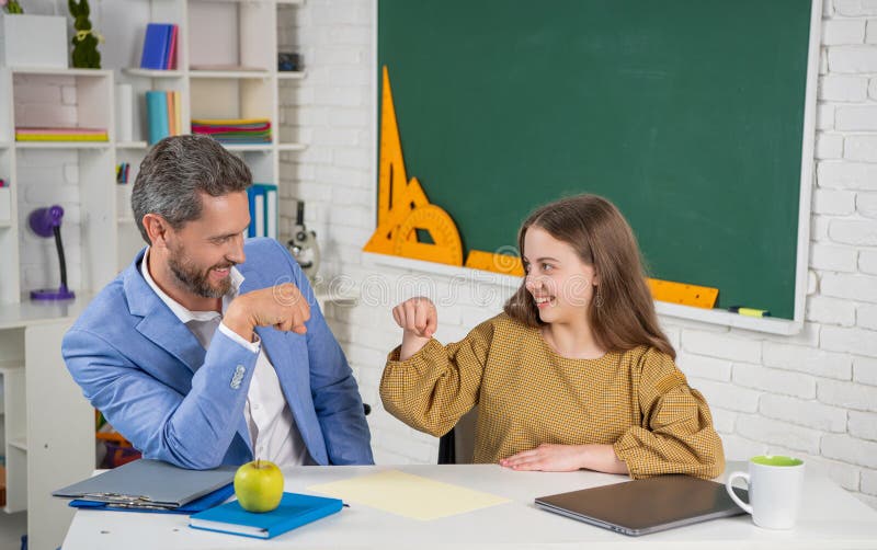 Happy Child Study in Classroom with Tutor. Fist To Fist Stock Photo ...