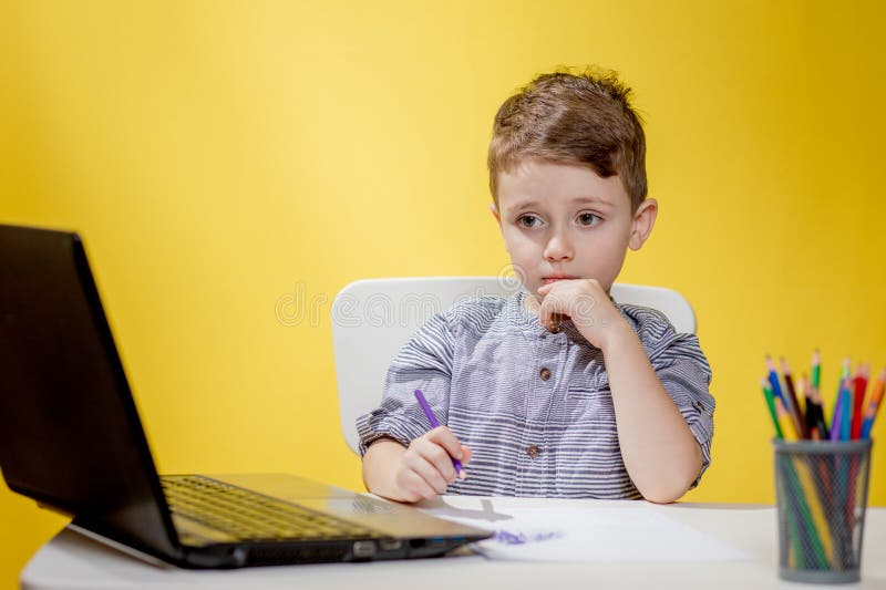 Happy Child Using Digital Laptop Doing Homework on Yellow Background ...