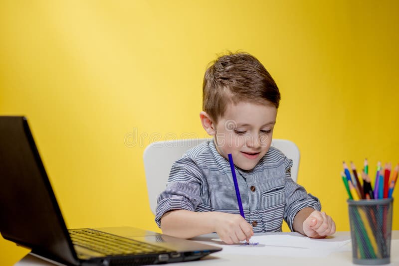 Happy Child Using Digital Laptop Doing Homework on Yellow Background ...