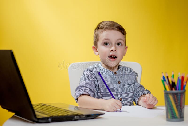 Happy Child Using Digital Laptop Doing Homework on Yellow Background ...