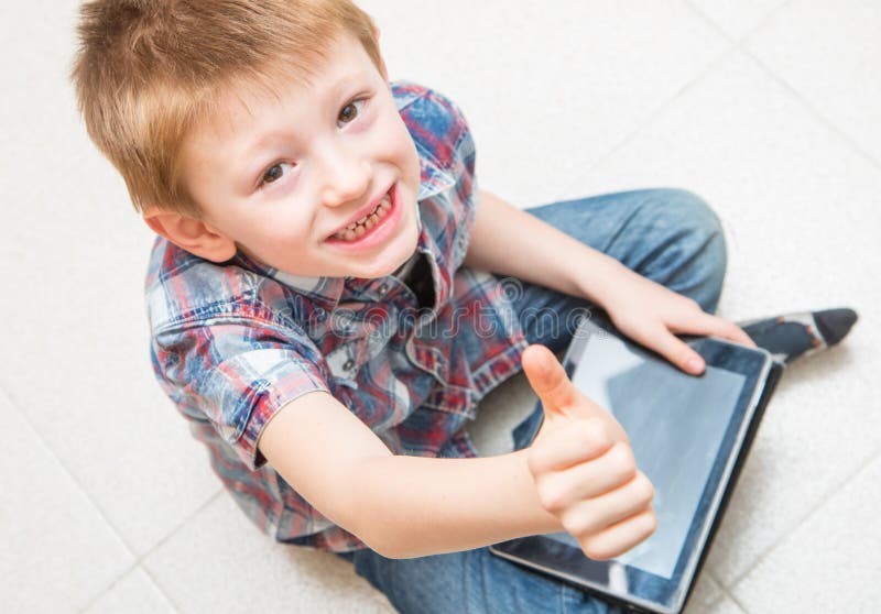 Happy Child is Watching the Tablet Stock Photo - Image of house, girl ...