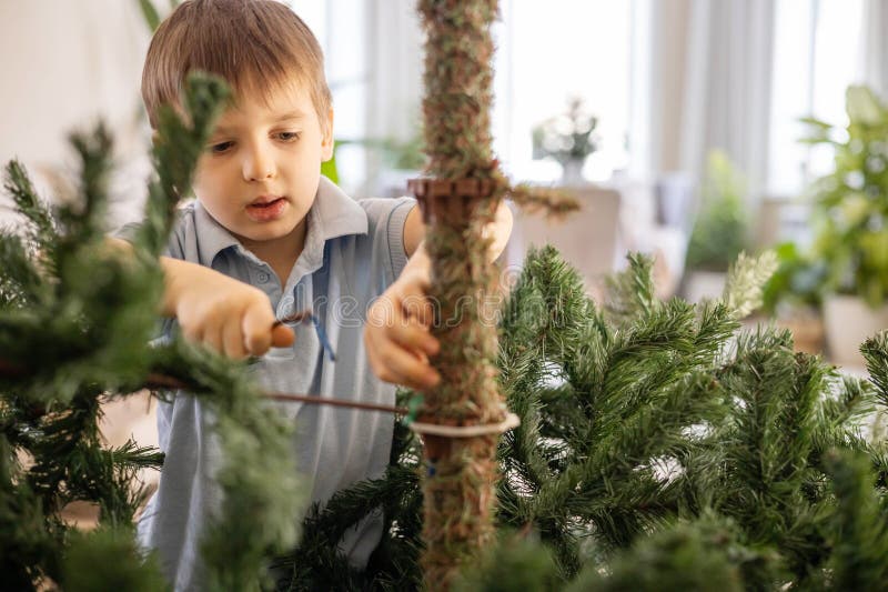Happy Children Assembling an Artificial Christmas Tree at Home in the ...