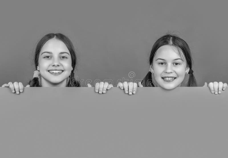 Happy Children Behind Blank Orange Paper with Copy Space for ...